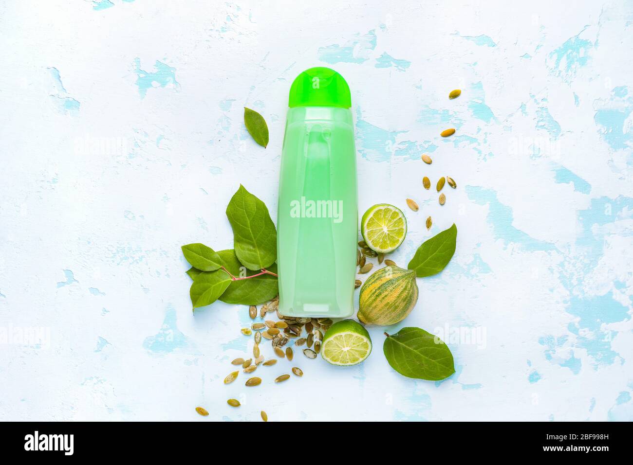 Composition with shampoo and natural ingredients on light background ...