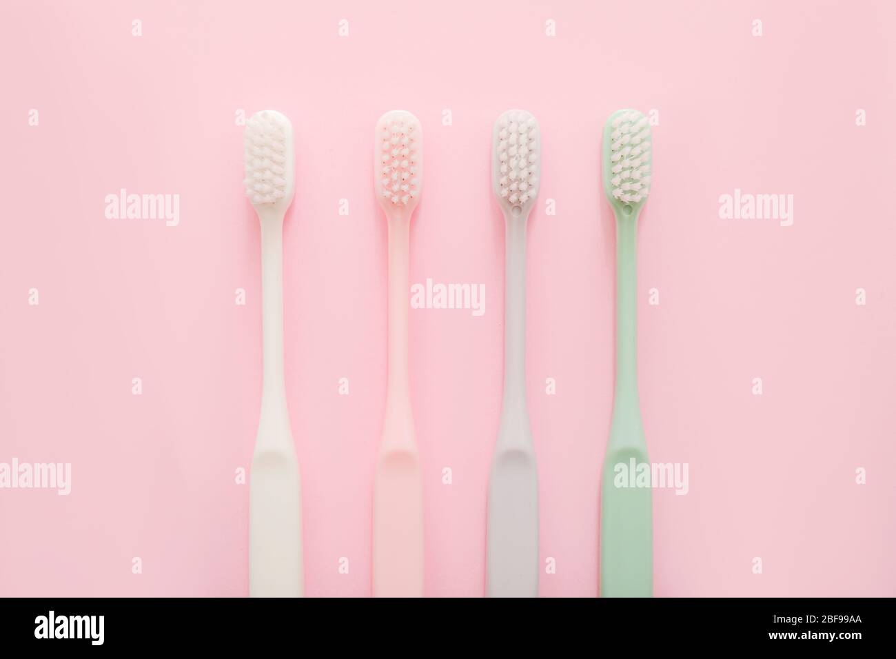 Tooth brushes on color background Stock Photo - Alamy