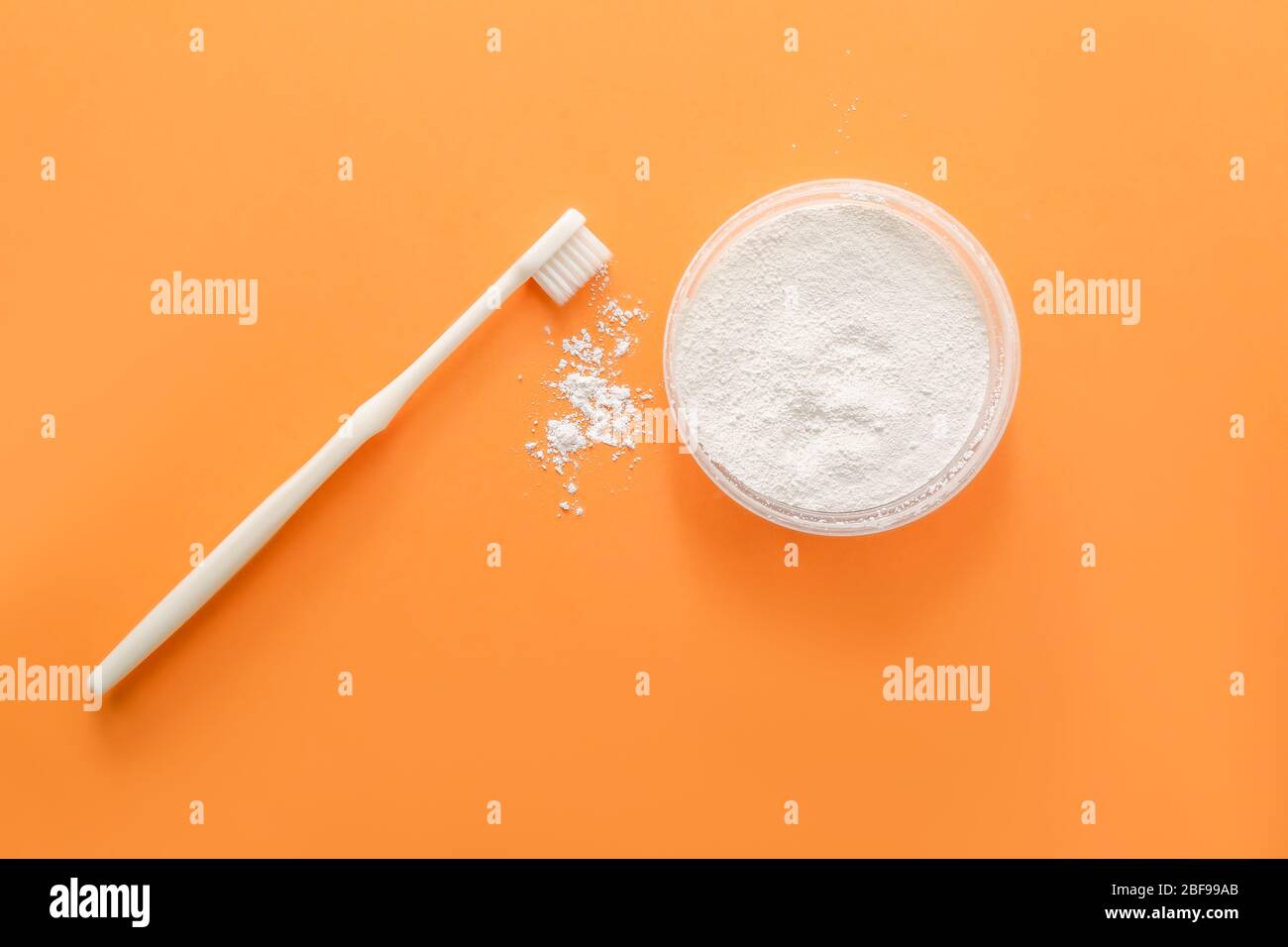 Tooth brush and powder on color background Stock Photo - Alamy