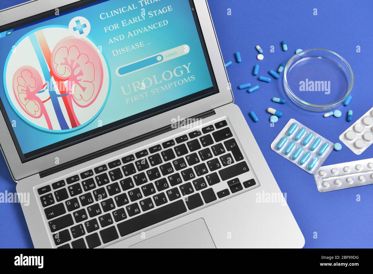 Laptop and medicines on color background. Concept of urology Stock ...