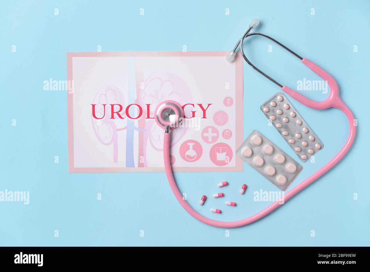 Paper sheet with text UROLOGY, stethoscope and medicines on color ...