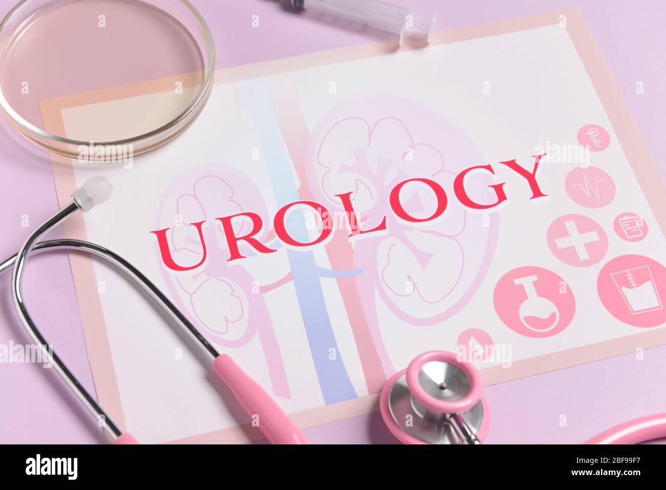 Paper sheet with text UROLOGY, stethoscope and urine sample on color ...