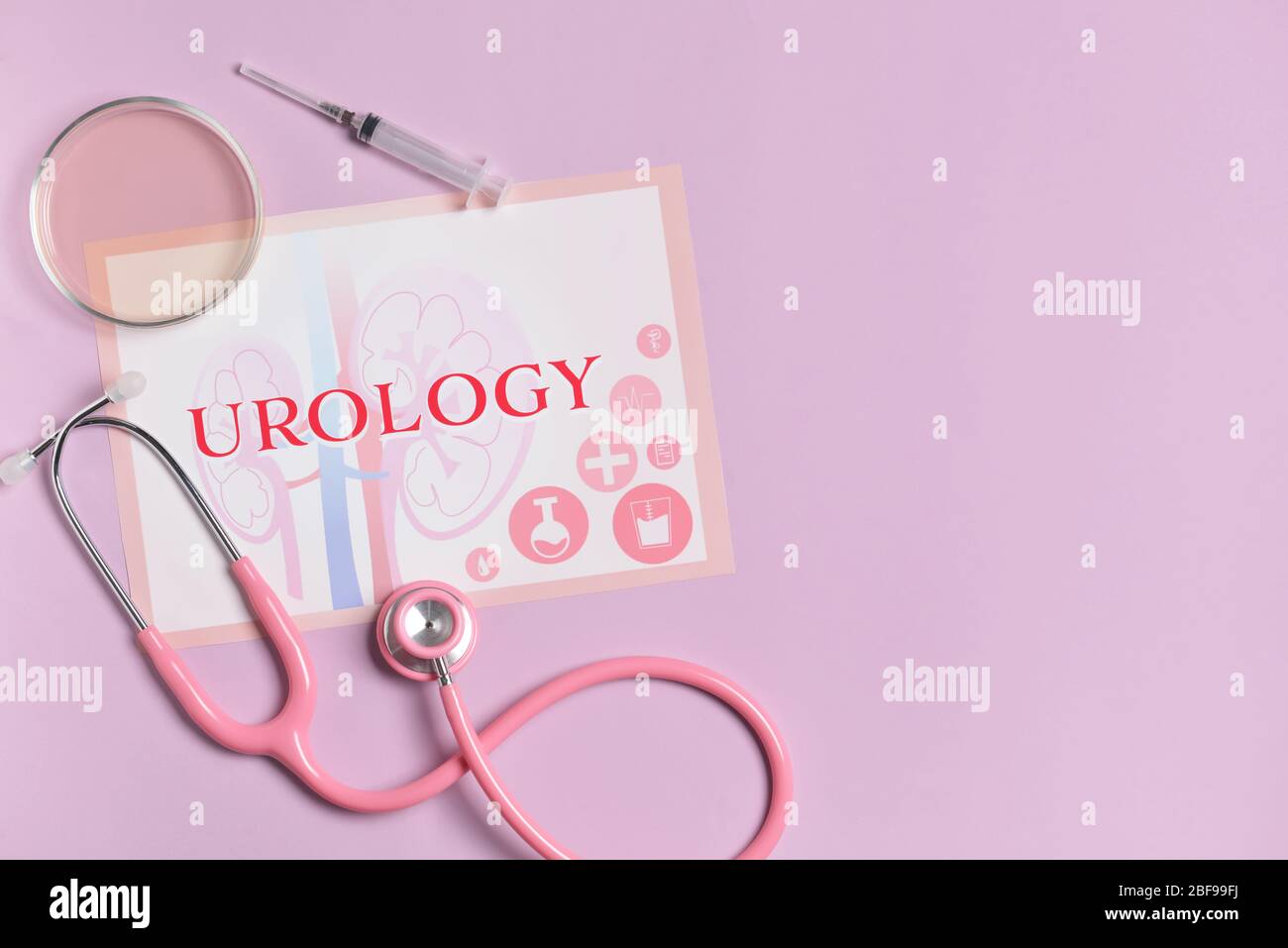 Paper sheet with text UROLOGY, stethoscope, urine sample and syringe on ...