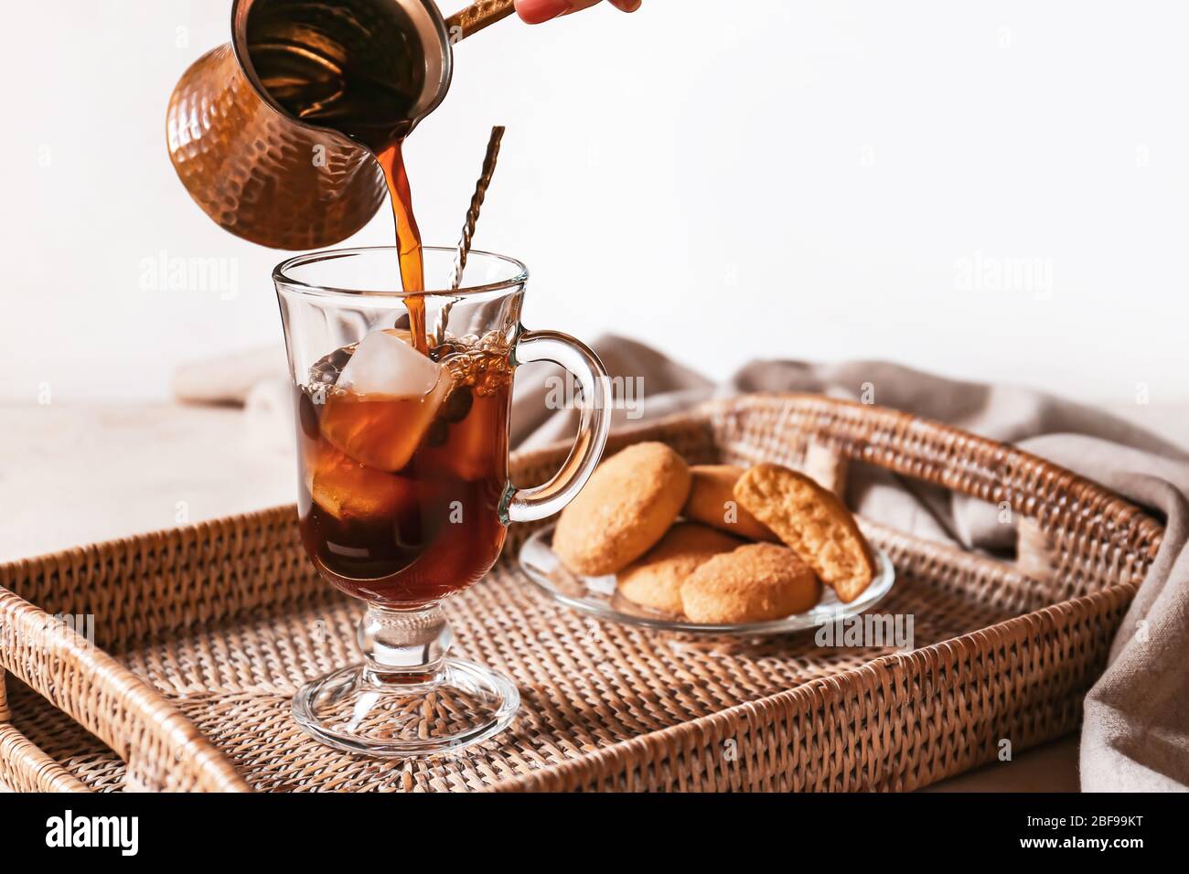 Pouring of coffee into in glass cup with ice cubes on tray Stock Photo ...