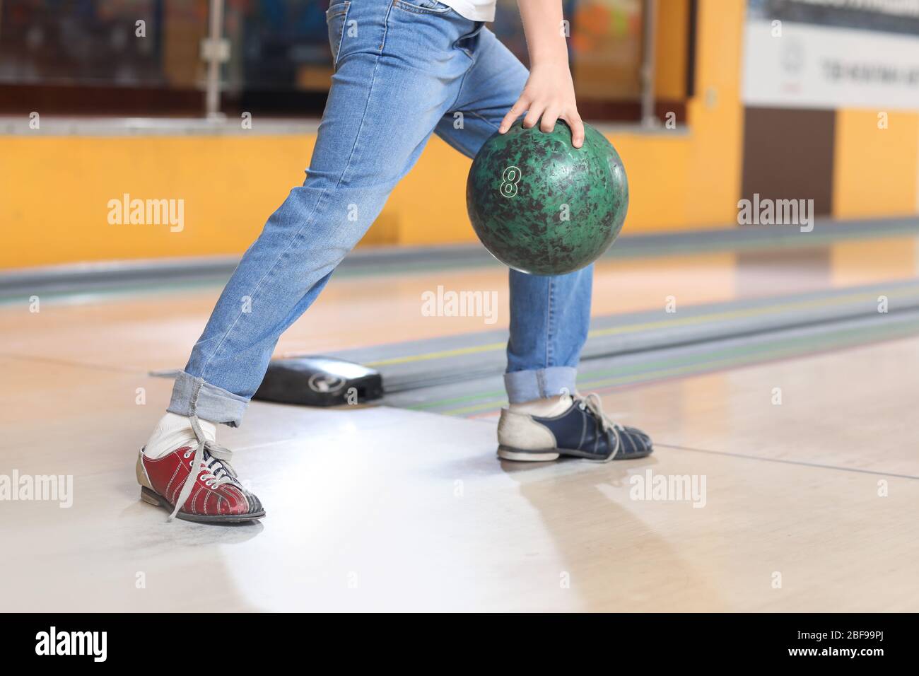 Little boy playing bowling in club Stock Photo - Alamy