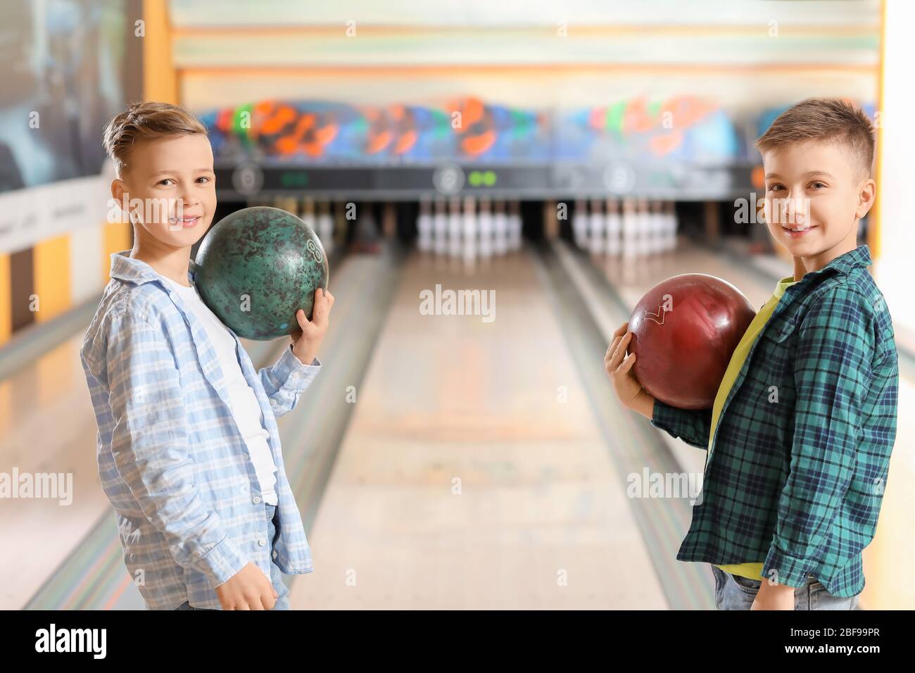 Little boys playing bowling in club Stock Photo - Alamy