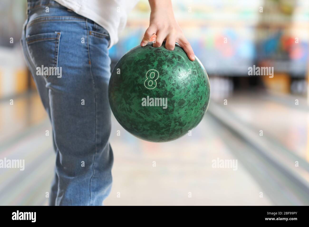 Little boy playing bowling in club Stock Photo - Alamy