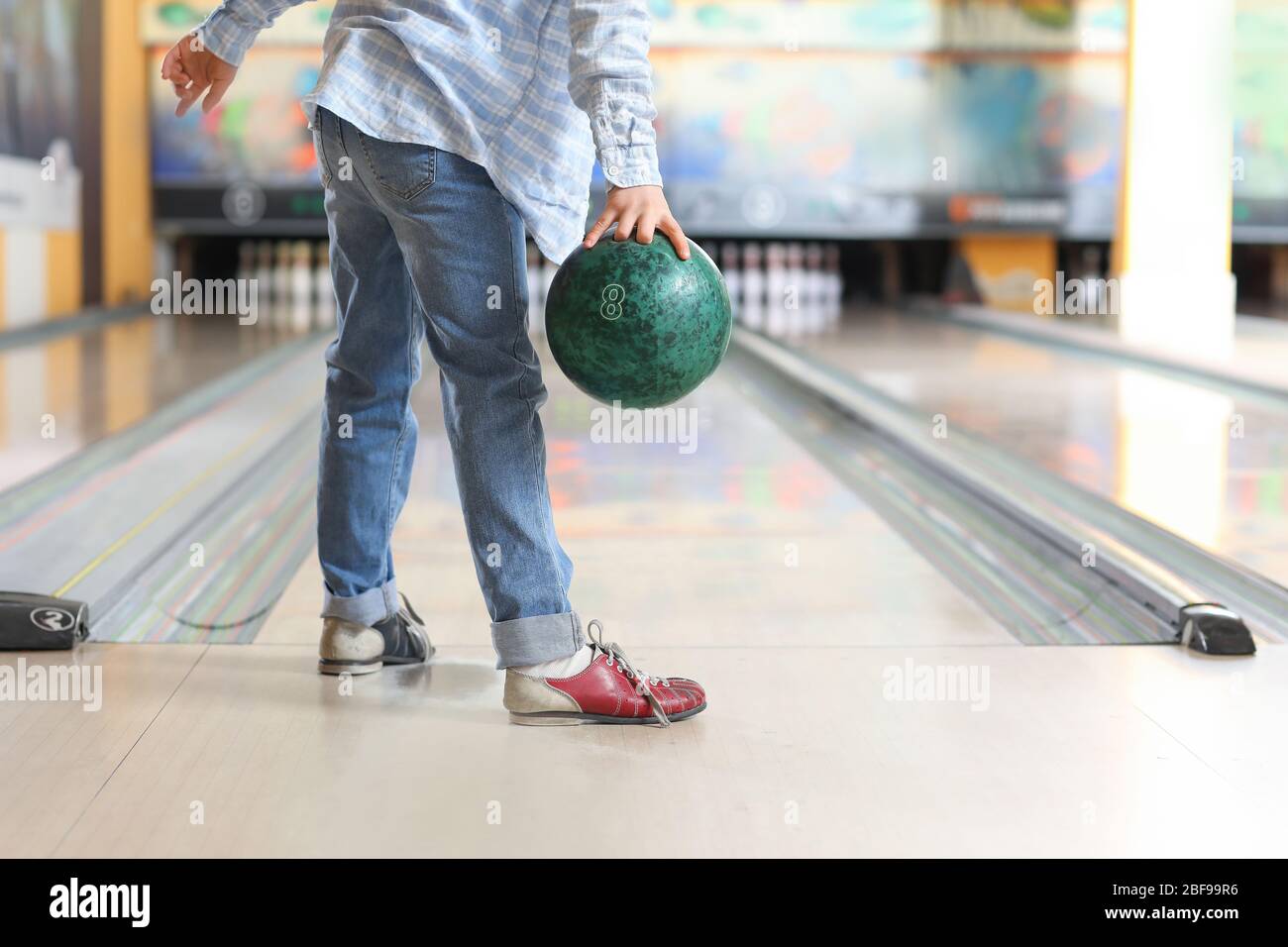 Little boy playing bowling in club Stock Photo - Alamy