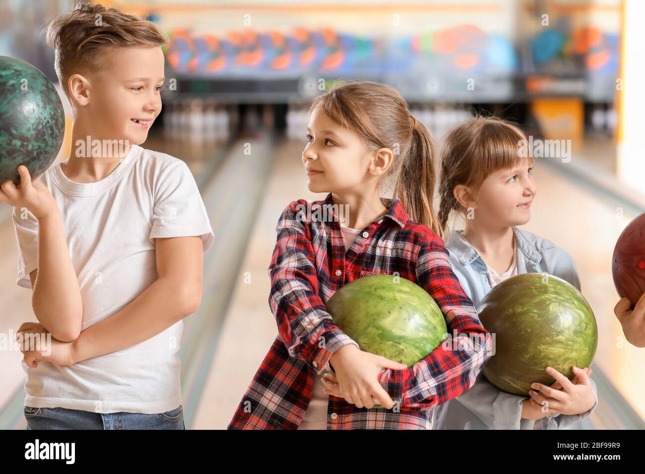 Little children playing bowling in club Stock Photo - Alamy