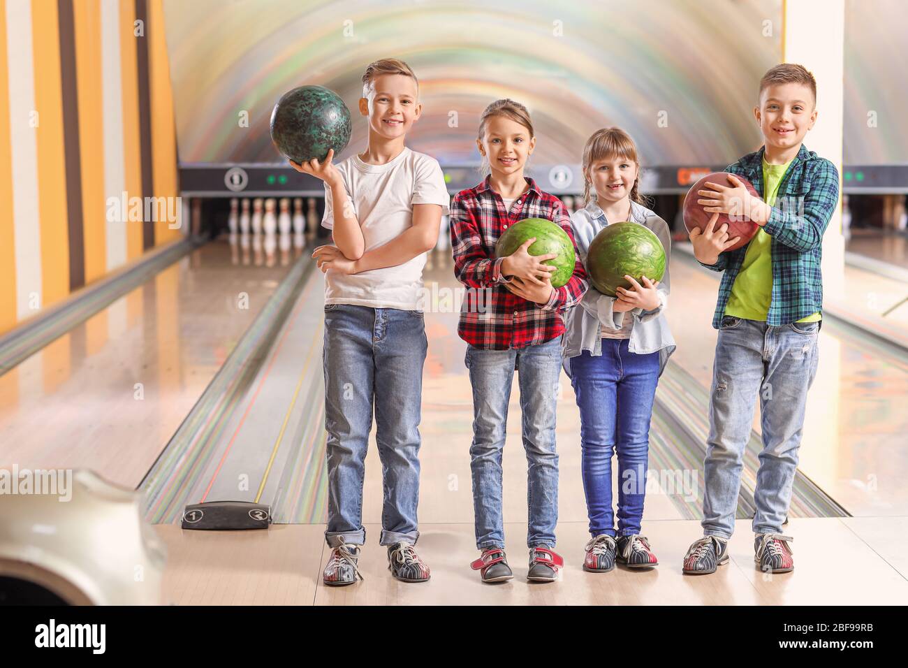 Little children playing bowling in club Stock Photo - Alamy