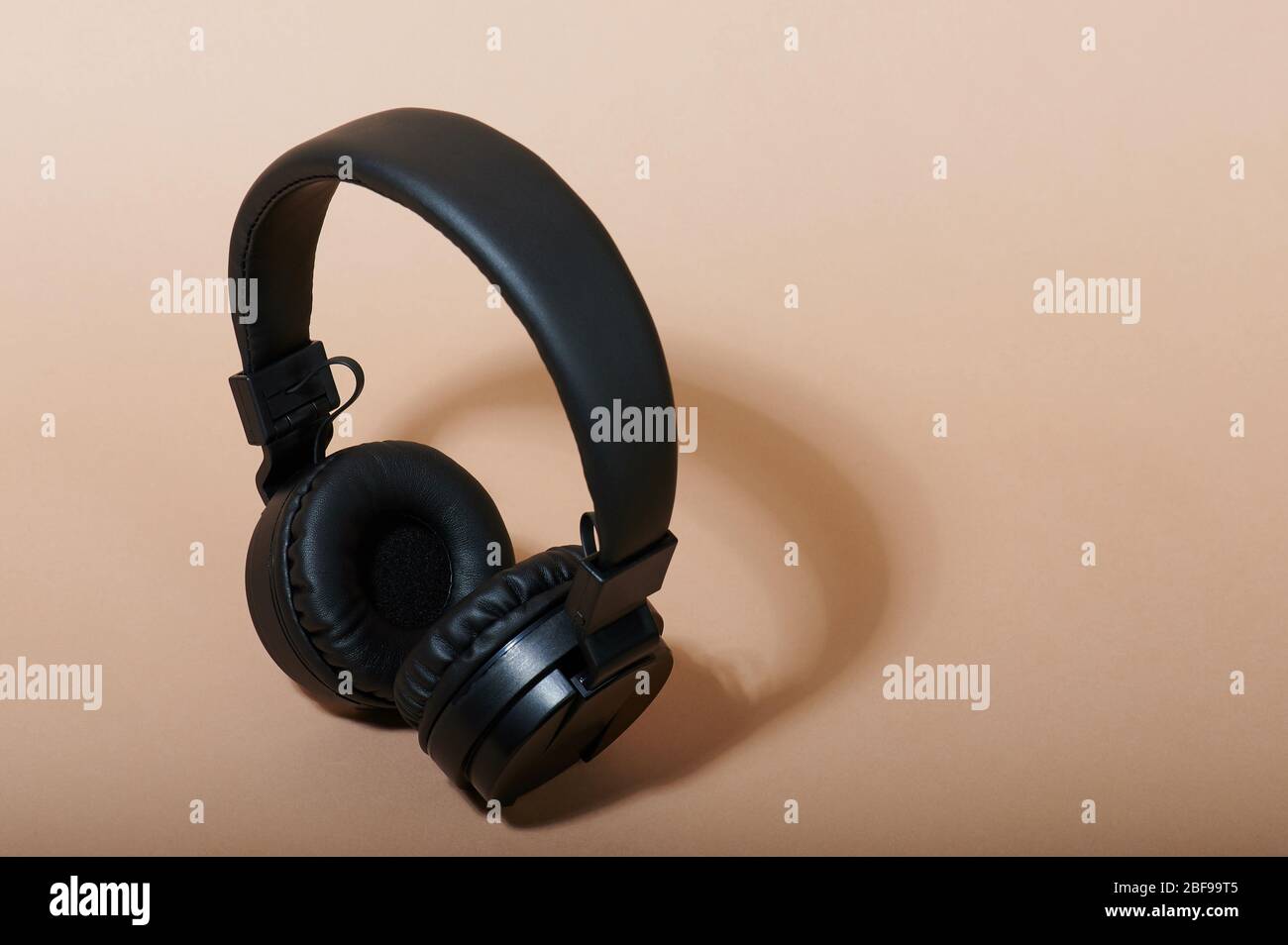 Black headphones above top view on beige color background Stock Photo ...