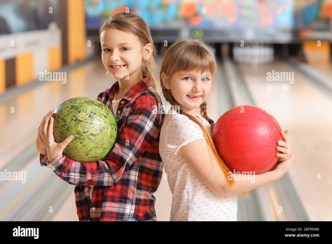 Little girls playing bowling in club Stock Photo - Alamy