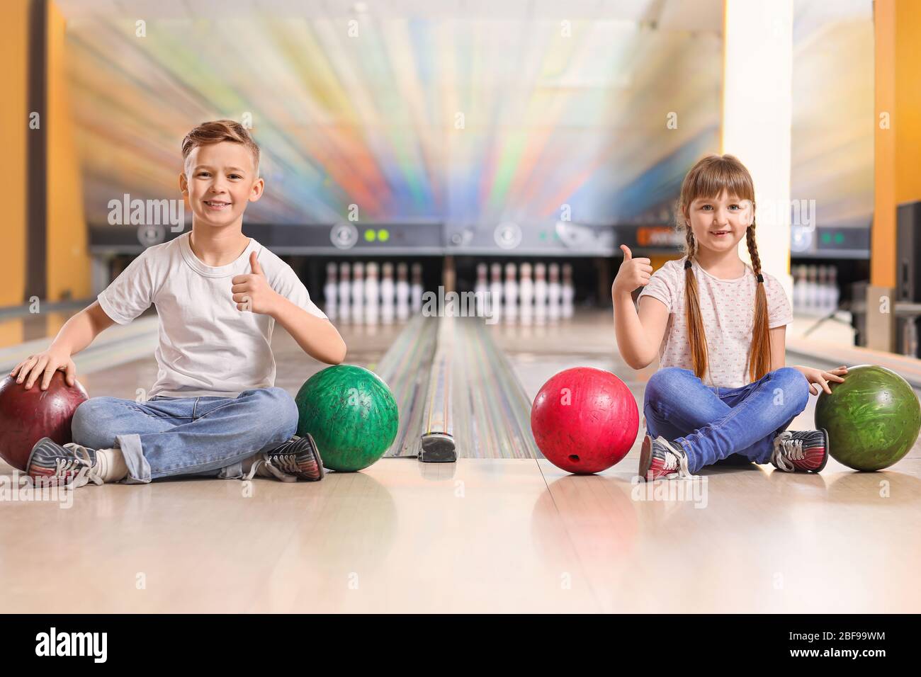 Little children playing bowling in club Stock Photo - Alamy