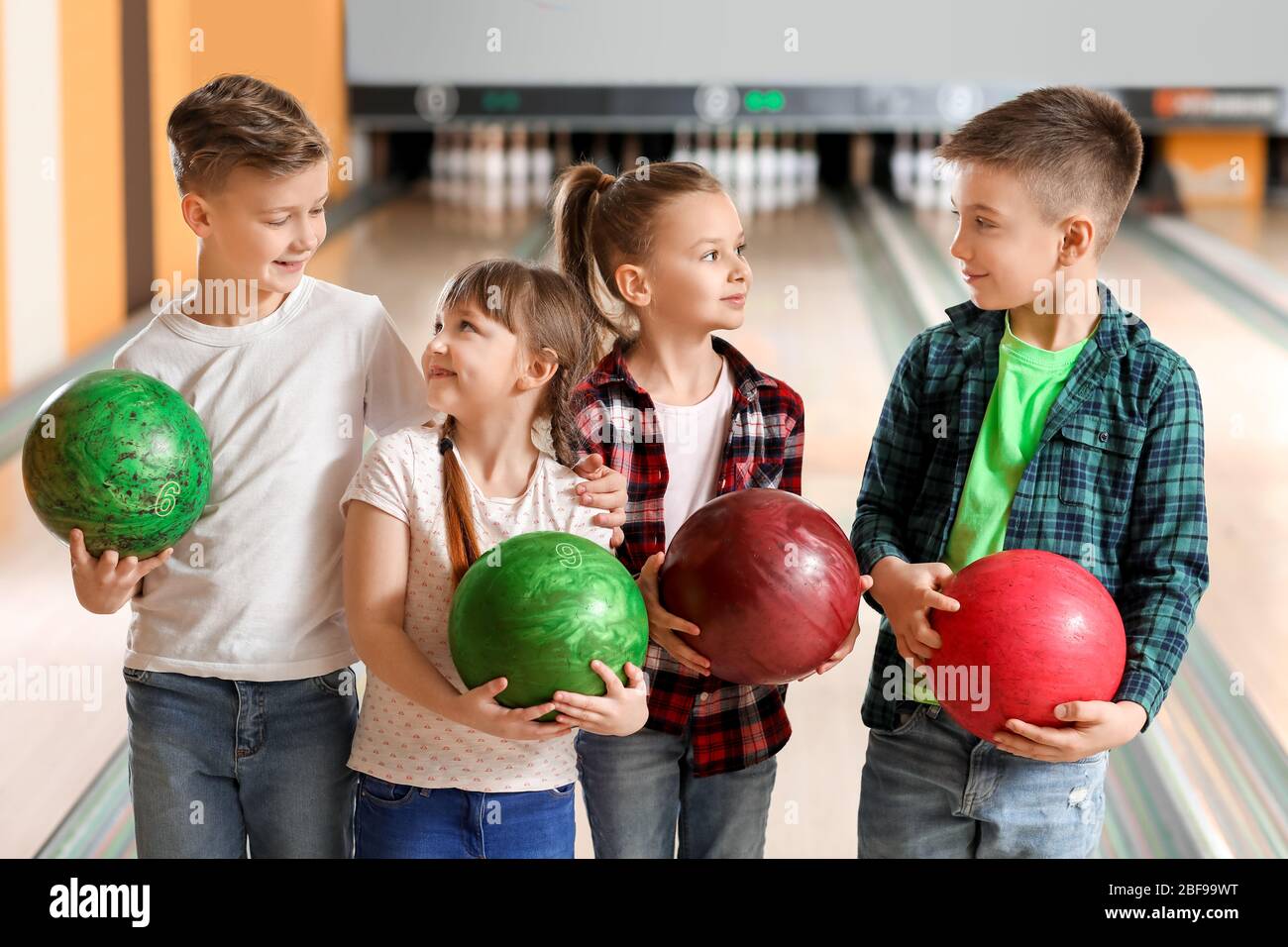 Little children playing bowling in club Stock Photo - Alamy
