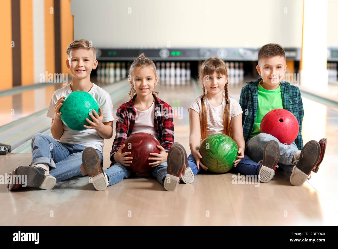 Little children playing bowling in club Stock Photo - Alamy