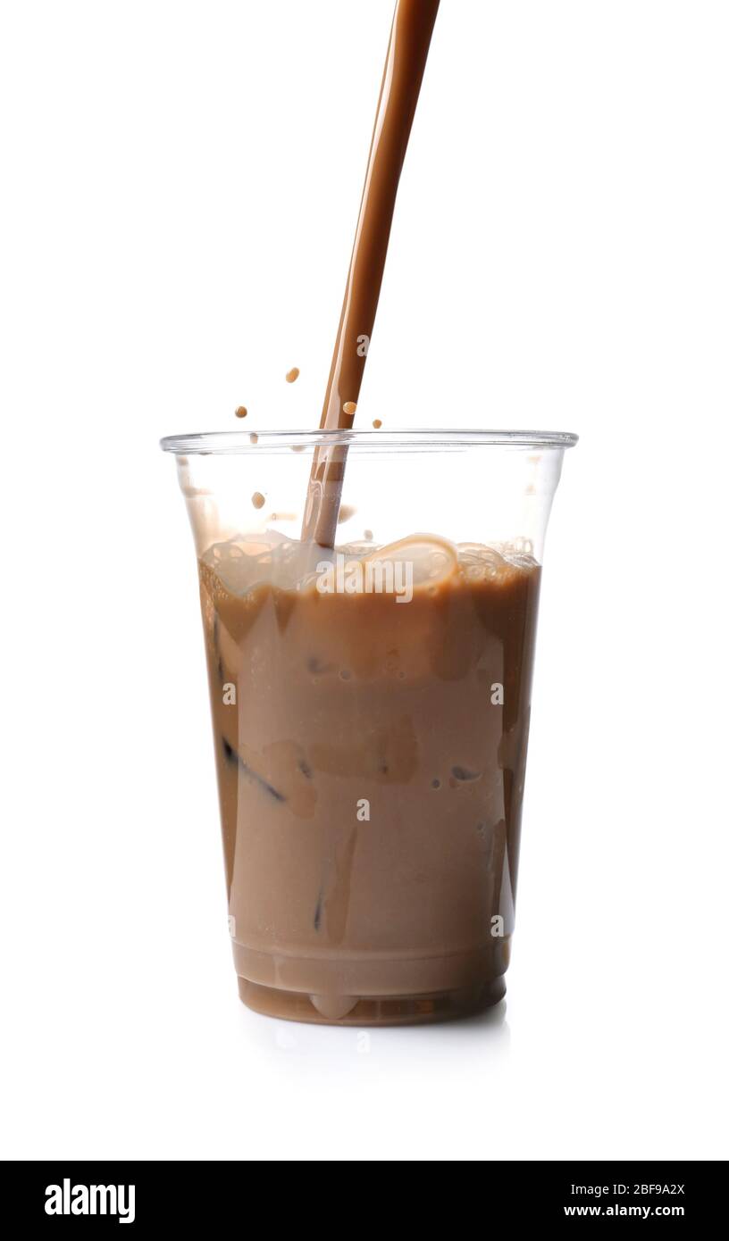 Pouring of coffee in cup with ice cubes on white background Stock Photo ...