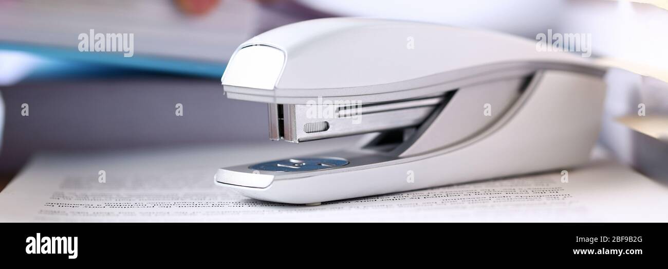 White stapler on workplace Stock Photo - Alamy