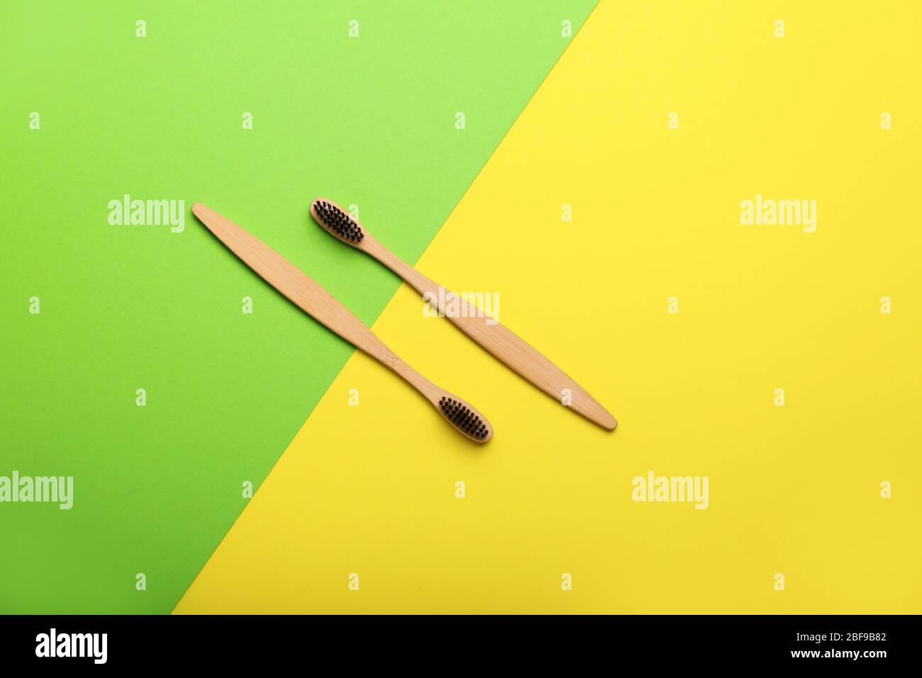 Tooth brushes on color background Stock Photo - Alamy