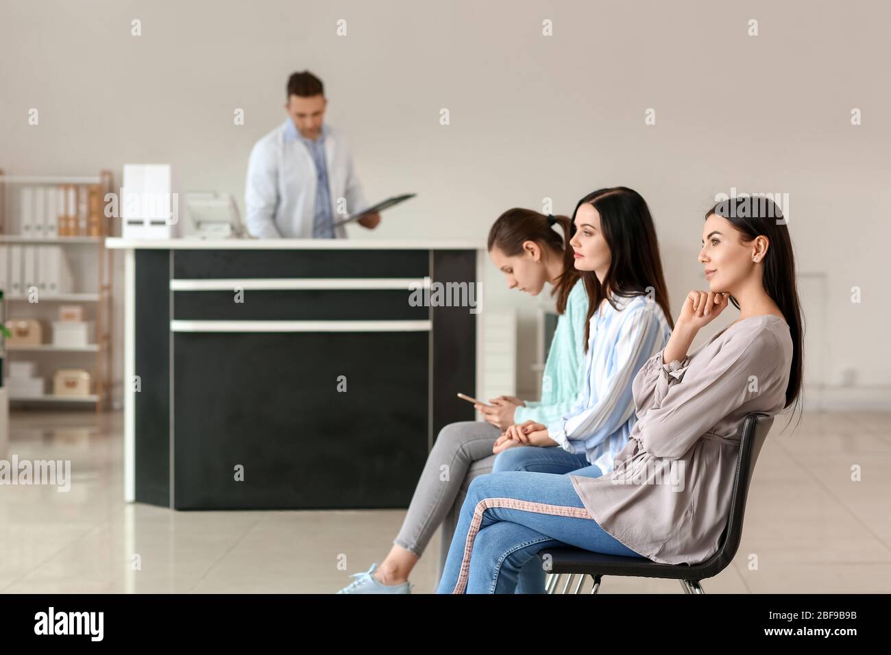Patients waiting in hall of clinic Stock Photo - Alamy