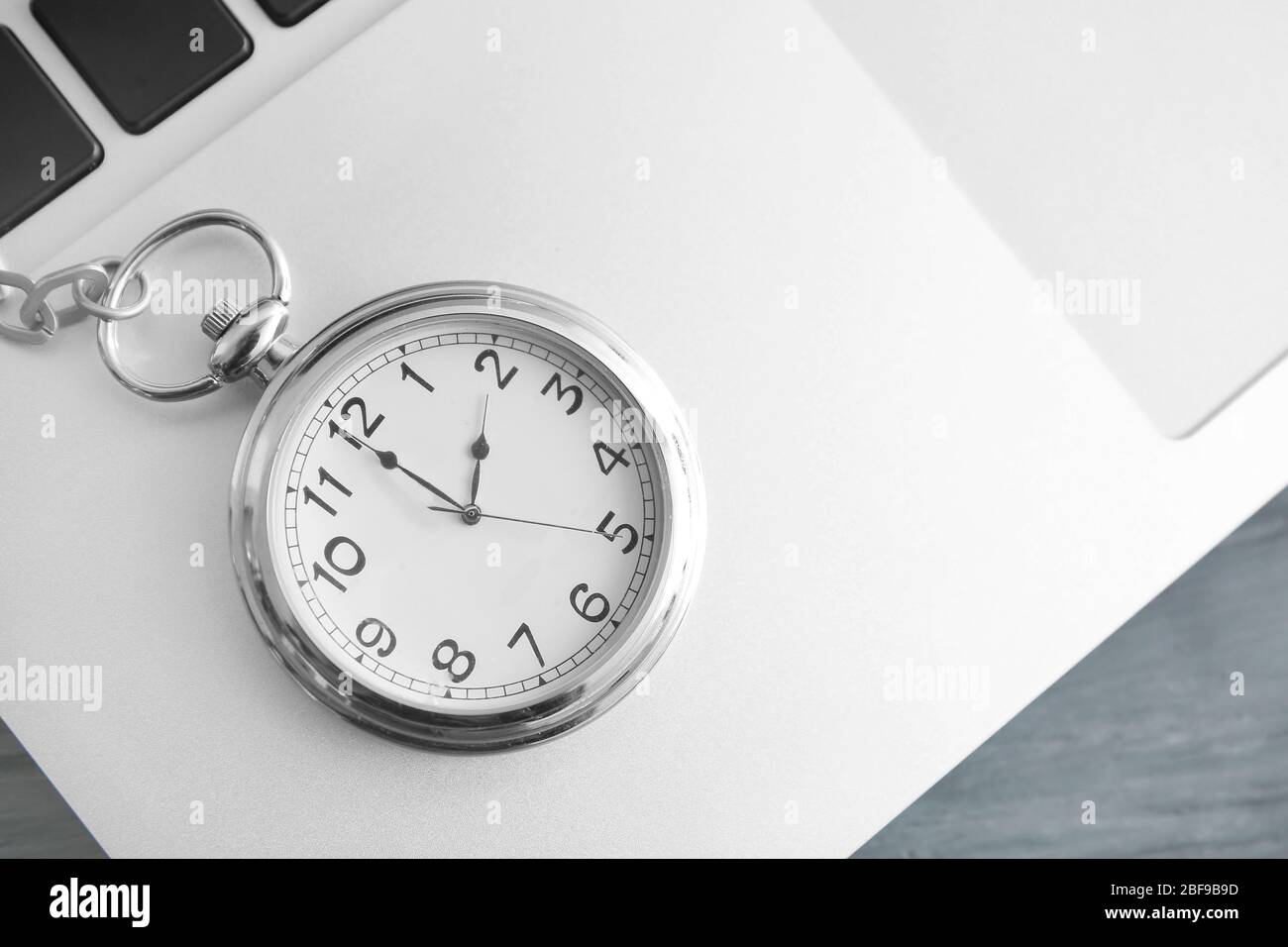 Clock on laptop, closeup. Time management concept Stock Photo - Alamy