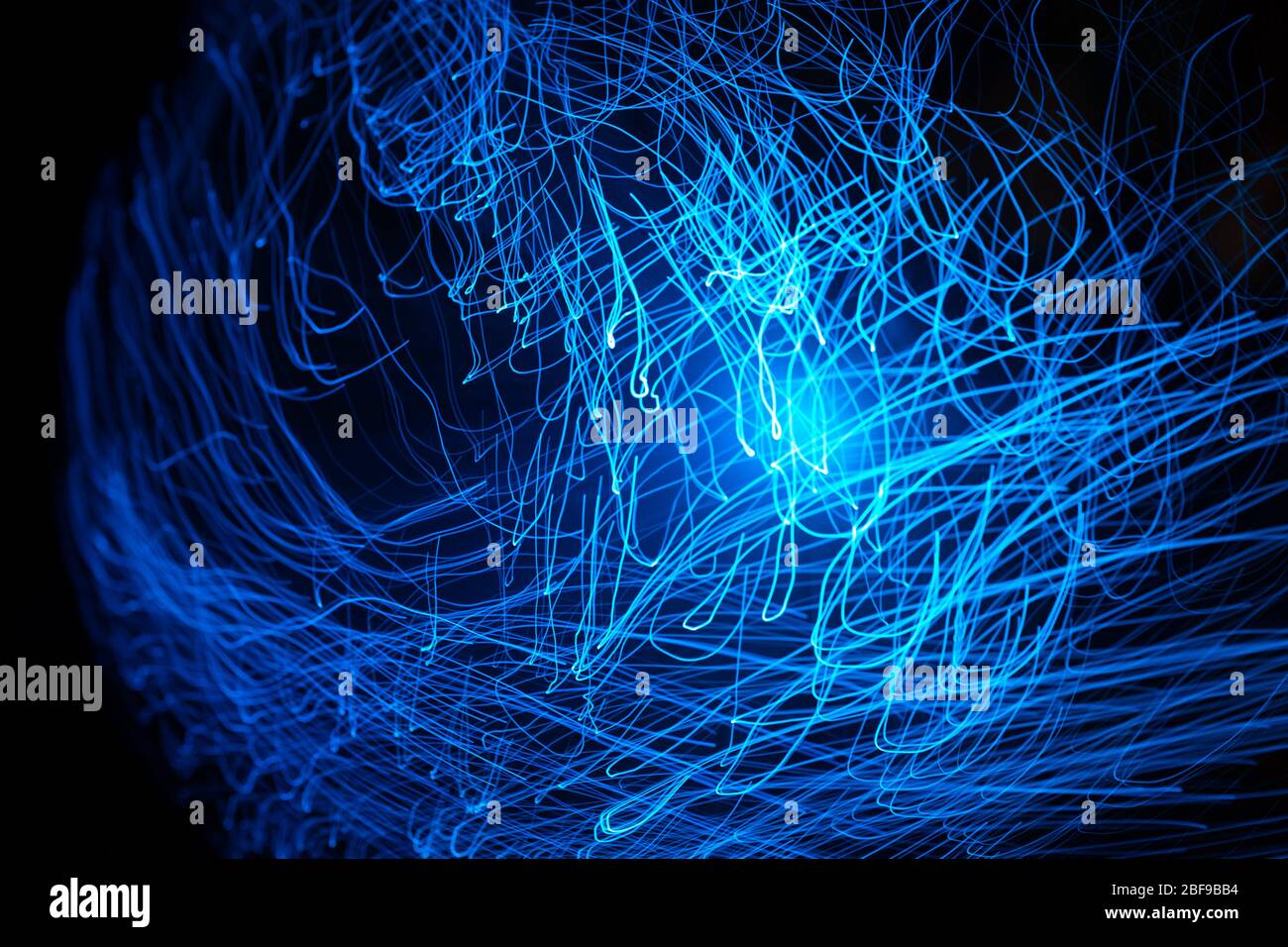 Blue abstract particles and lines with bokeh and blur in dark ...