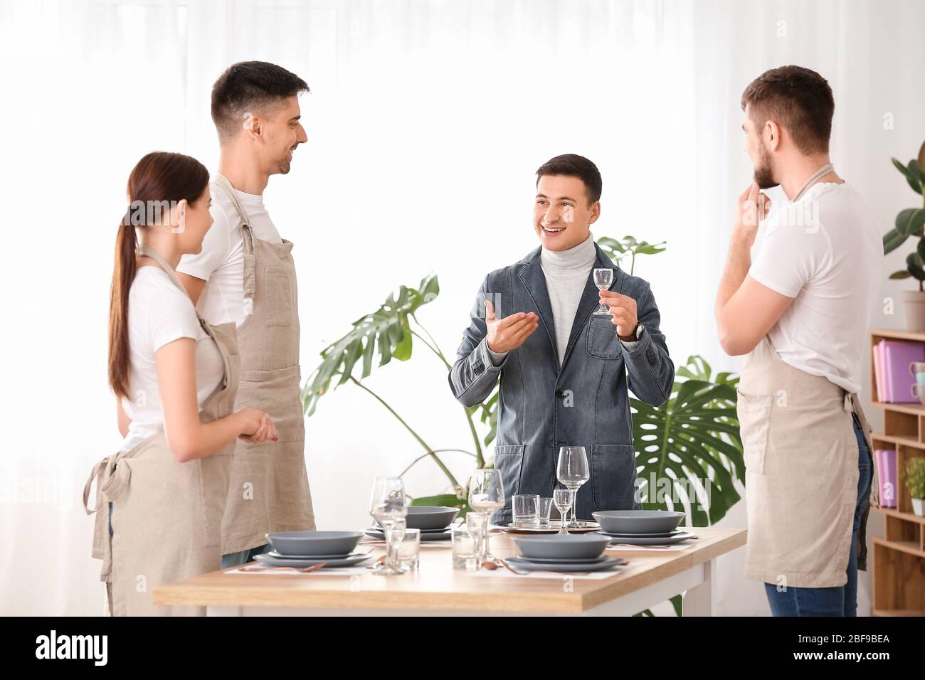 Young people attending professional waiter courses Stock Photo - Alamy