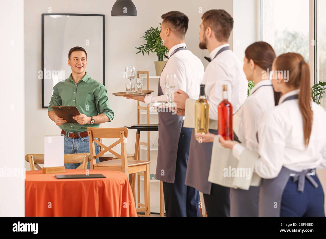 Young people attending professional waiter courses Stock Photo - Alamy
