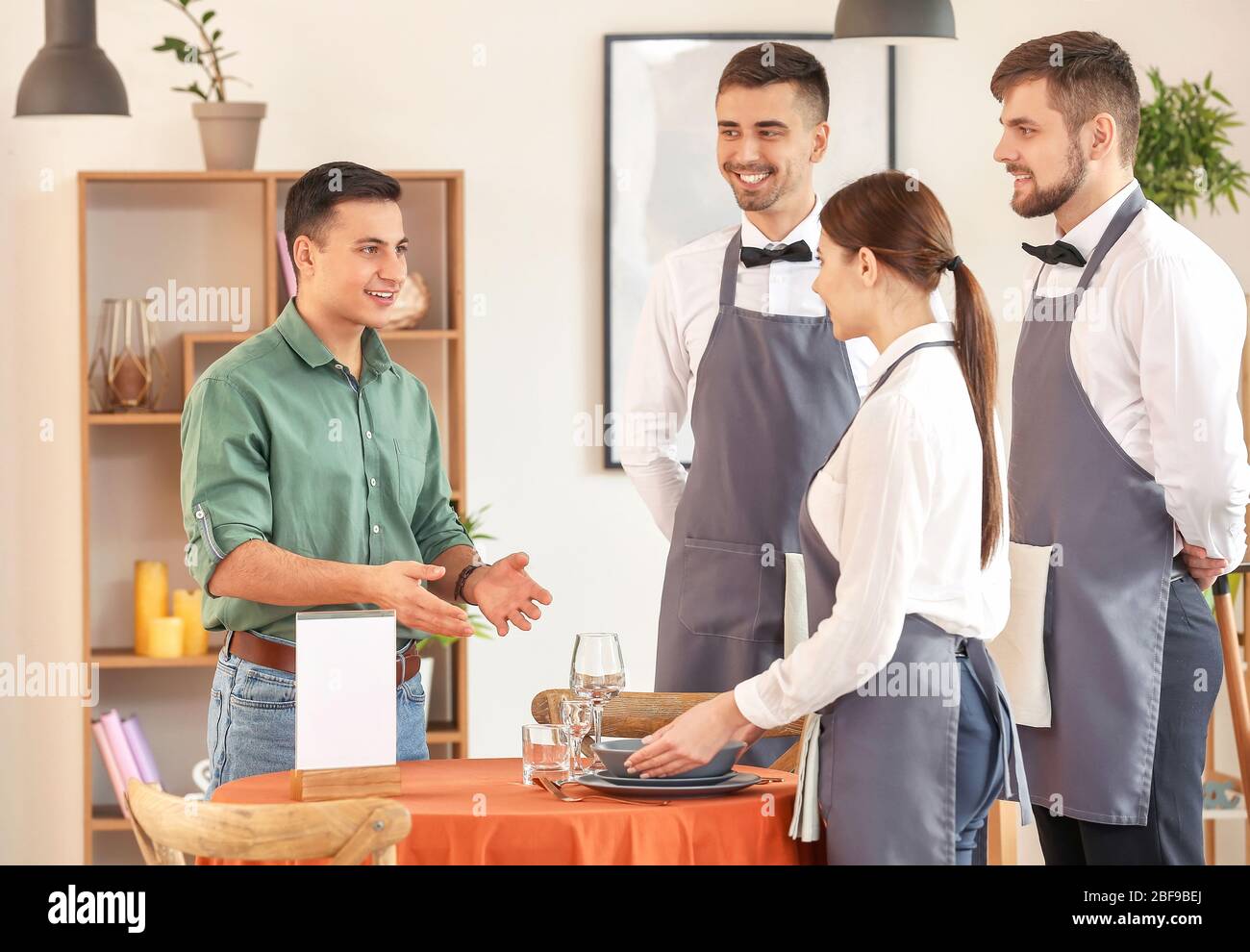 Young people attending professional waiter courses Stock Photo - Alamy