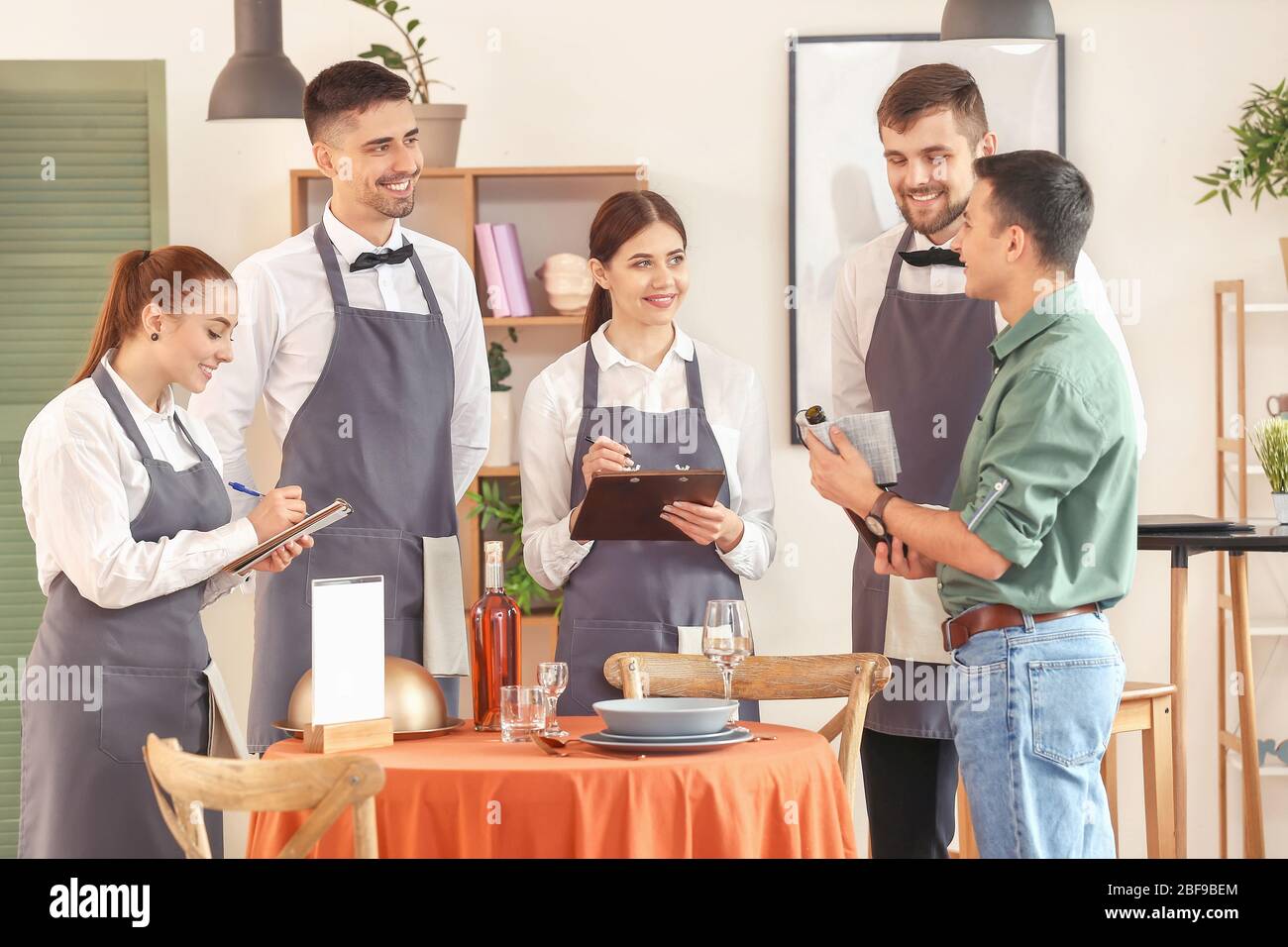 Young people attending professional waiter courses Stock Photo - Alamy