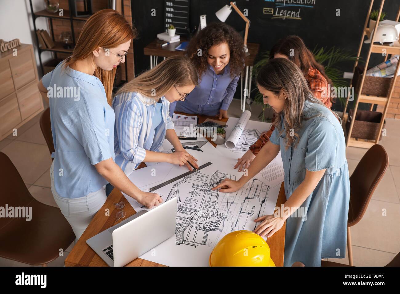 Architect teaching young people in office Stock Photo - Alamy