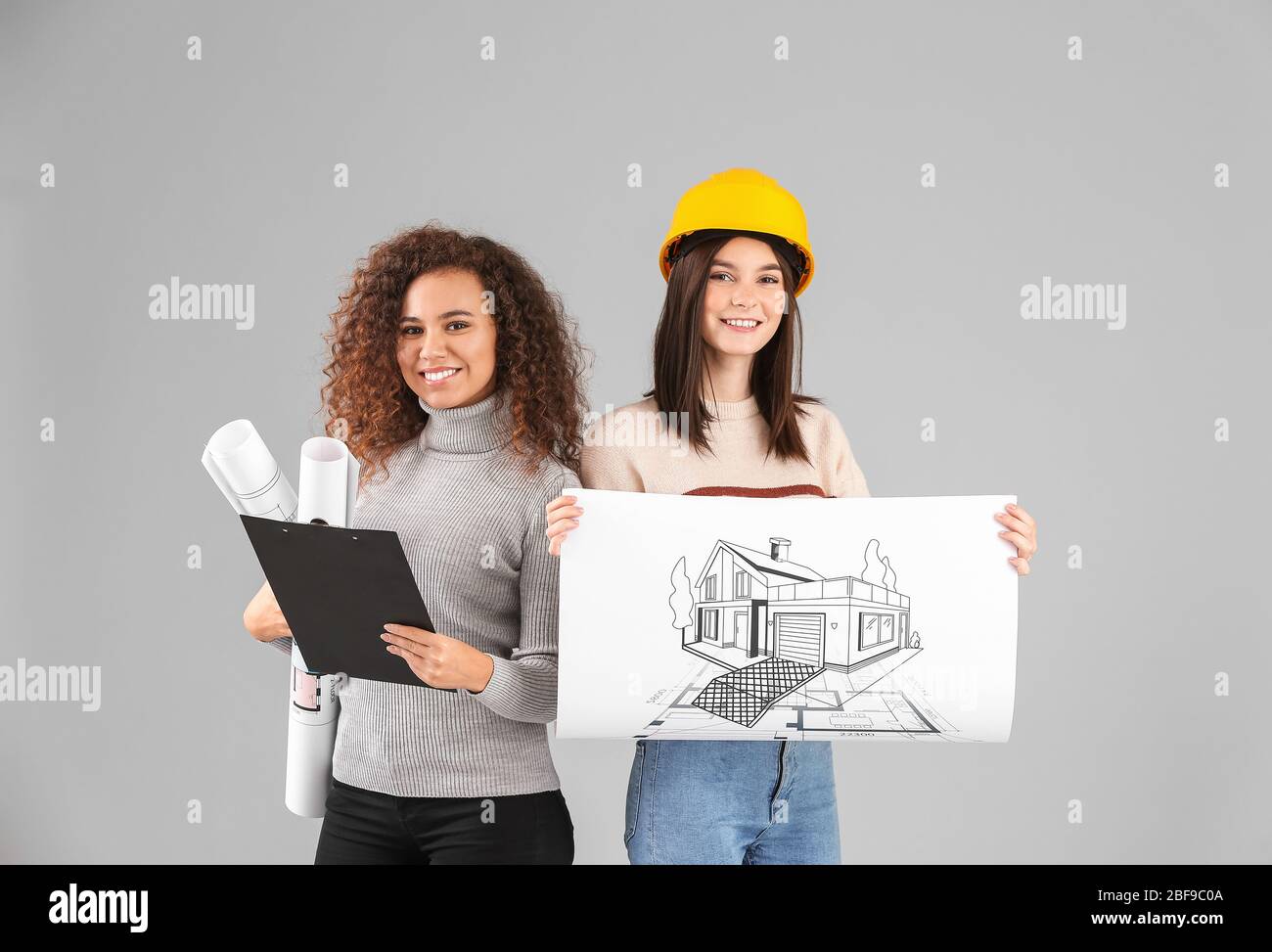 Portrait of architects on grey background Stock Photo - Alamy