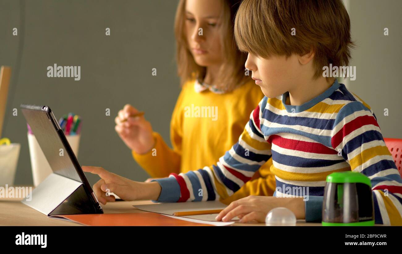 Distance learning of school subjects for daughter and son at home ...
