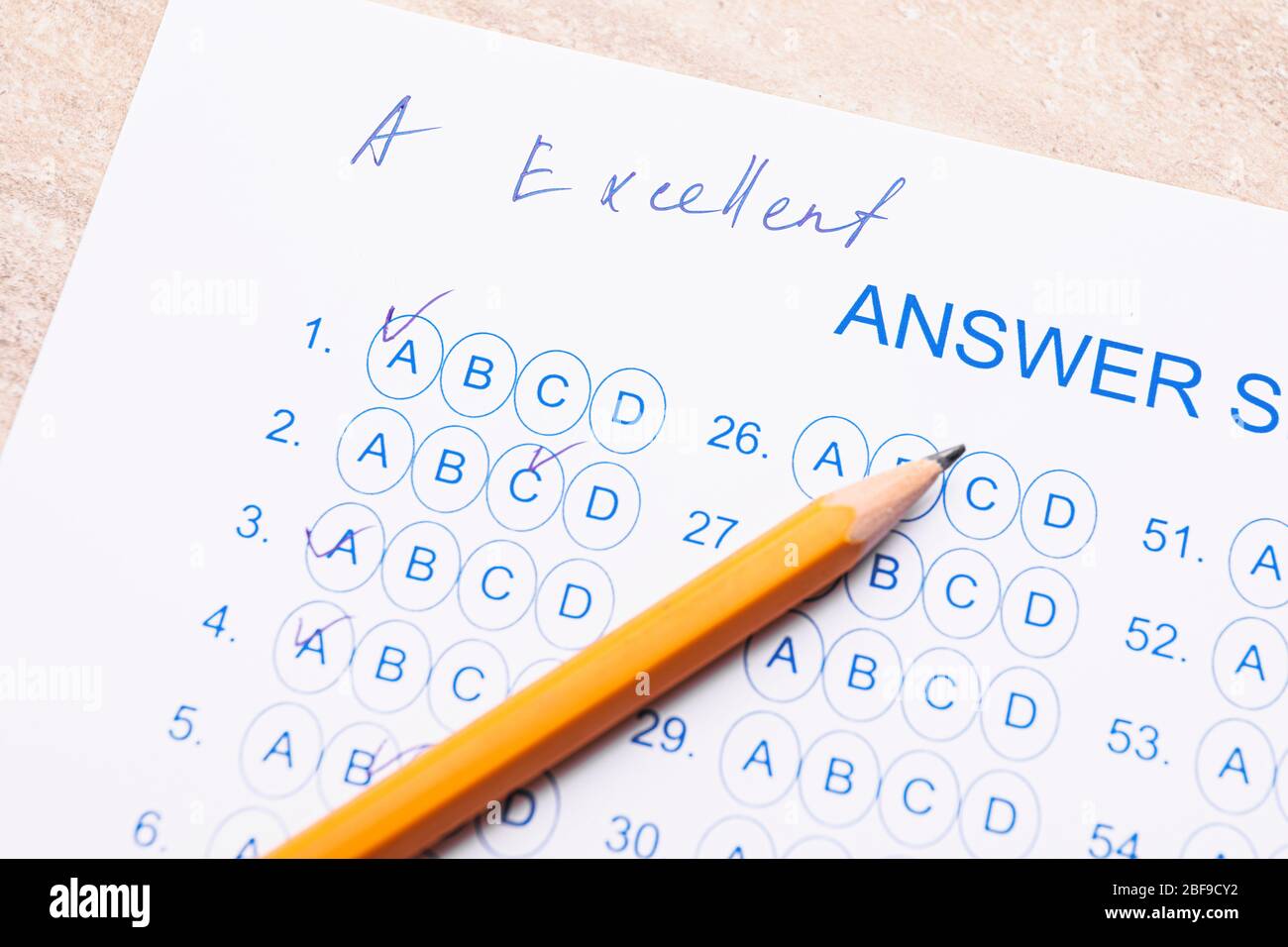 Checked answer sheet on table, closeup. Concept of passing exam Stock ...