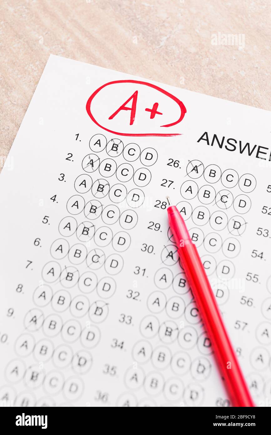 Checked answer sheet on table, closeup. Concept of passing exam Stock ...