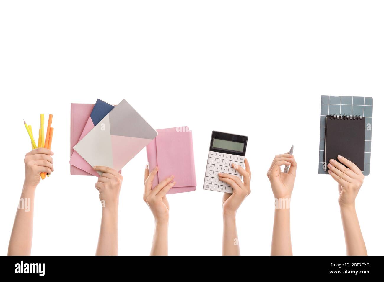 Many hands with school supplies on white background Stock Photo - Alamy