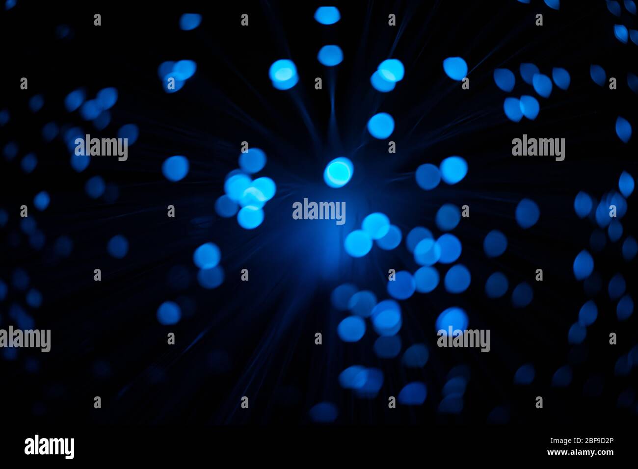 Blue abstract particles and lines with bokeh and blur in dark ...