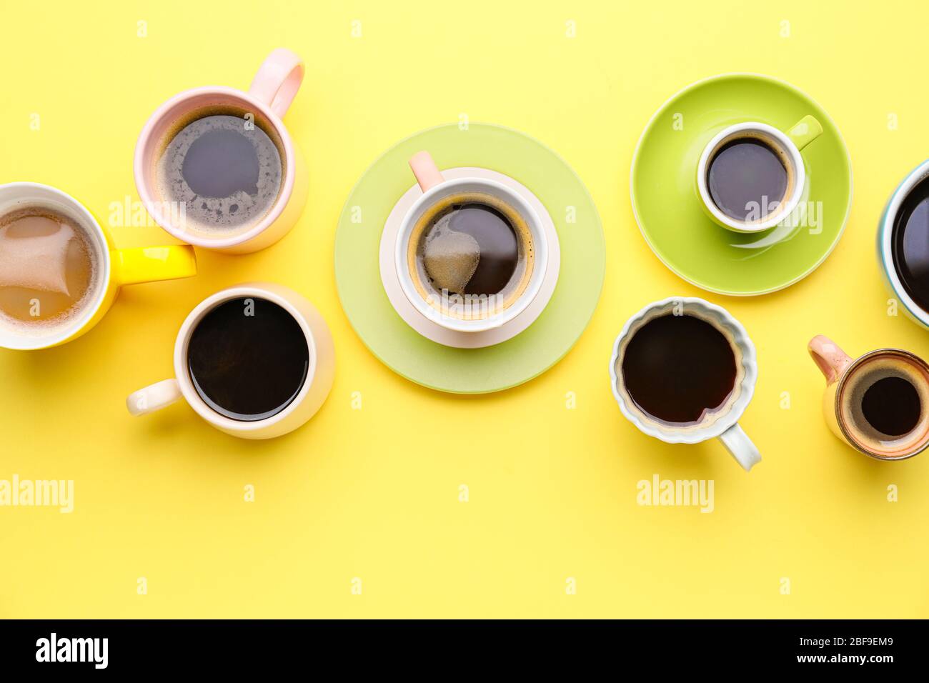 Cups of coffee on color background Stock Photo - Alamy