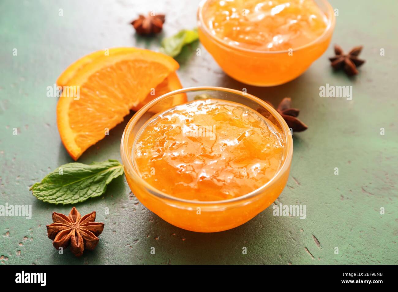 Bowl of orange jam on color background Stock Photo - Alamy