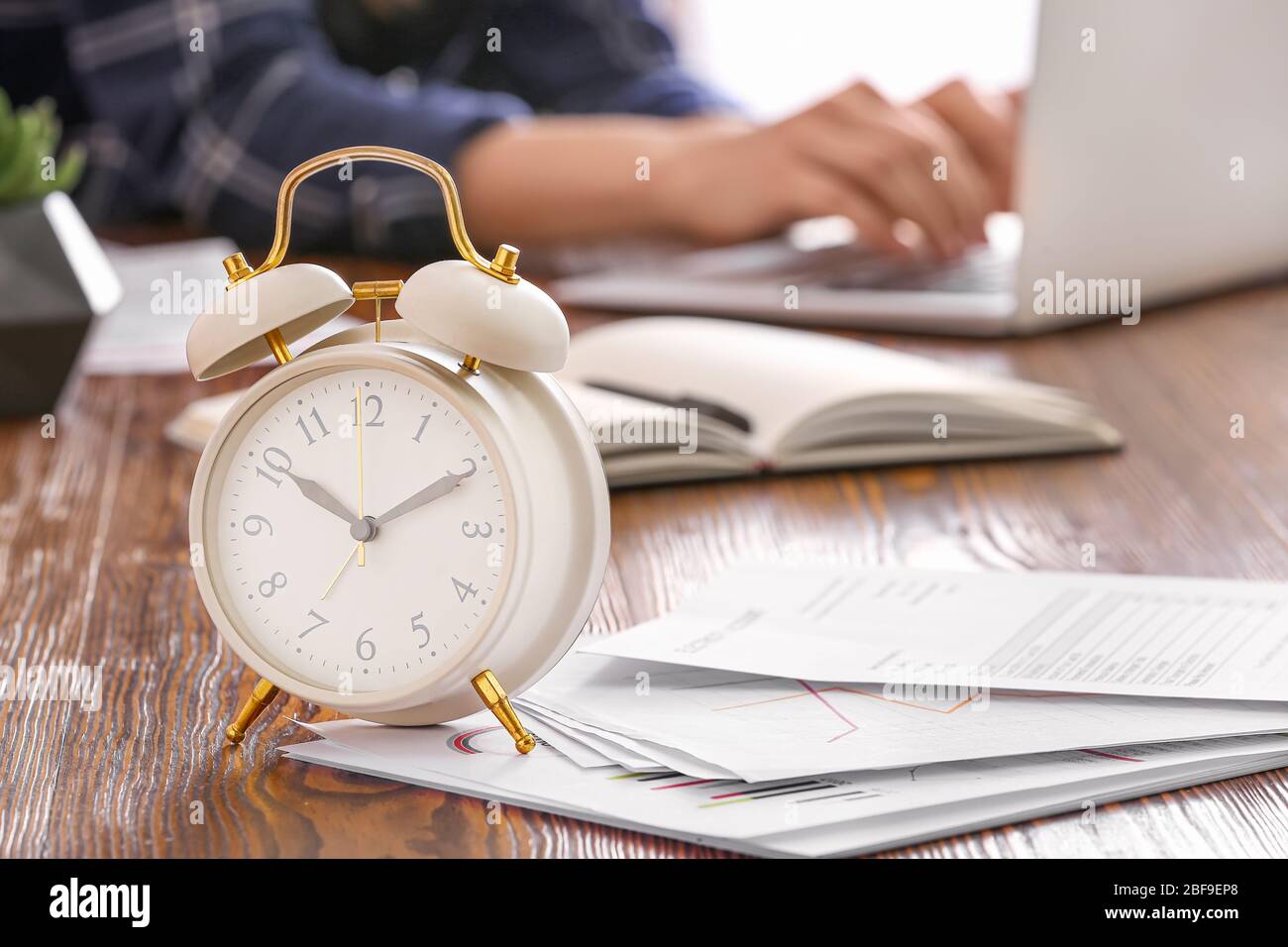 Alarm clock on office table. Time management concept Stock Photo - Alamy