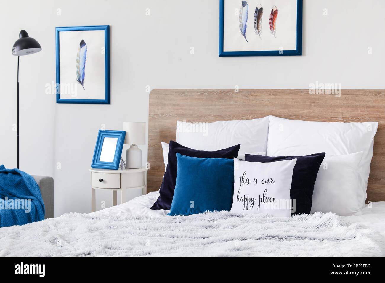Big comfortable bed in interior of room Stock Photo - Alamy