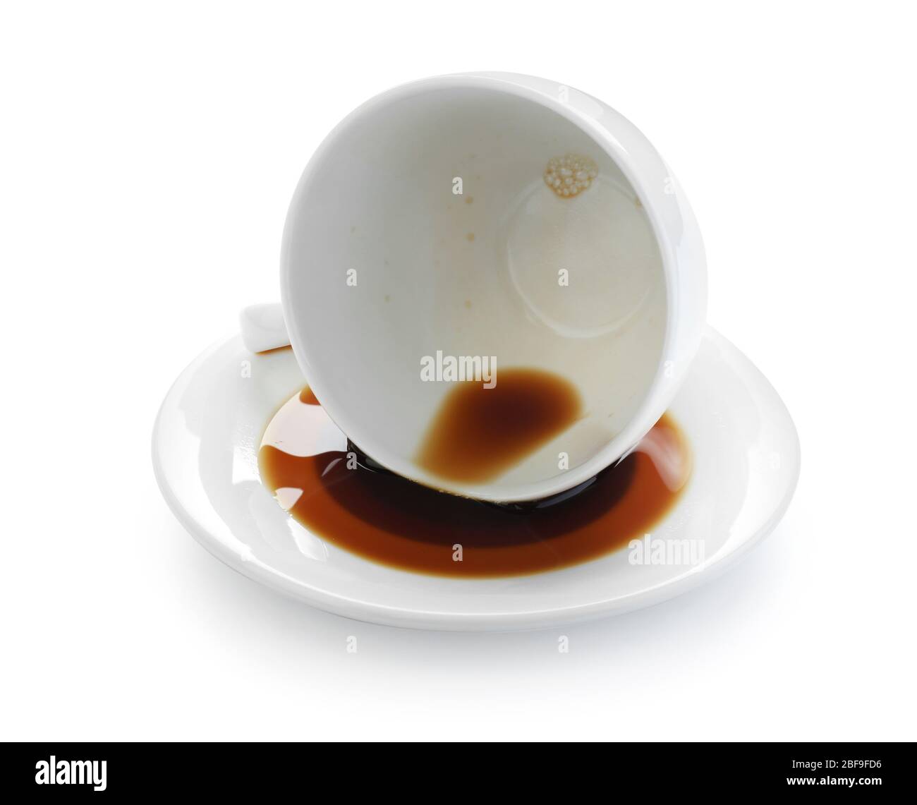 Overturned cup and spilled coffee on white background Stock Photo - Alamy