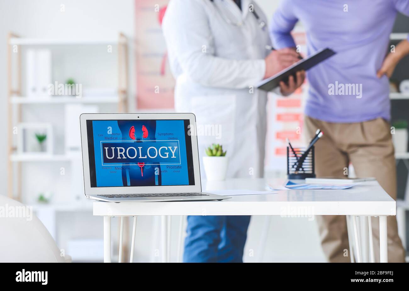 Modern laptop on table in urologist's office Stock Photo - Alamy