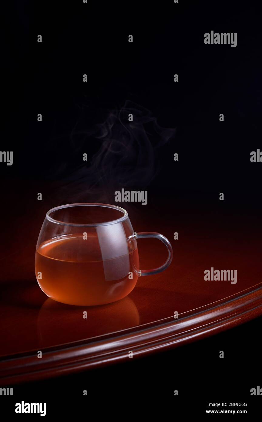 Cup of red tea on a luxurious table with a black background Stock Photo ...