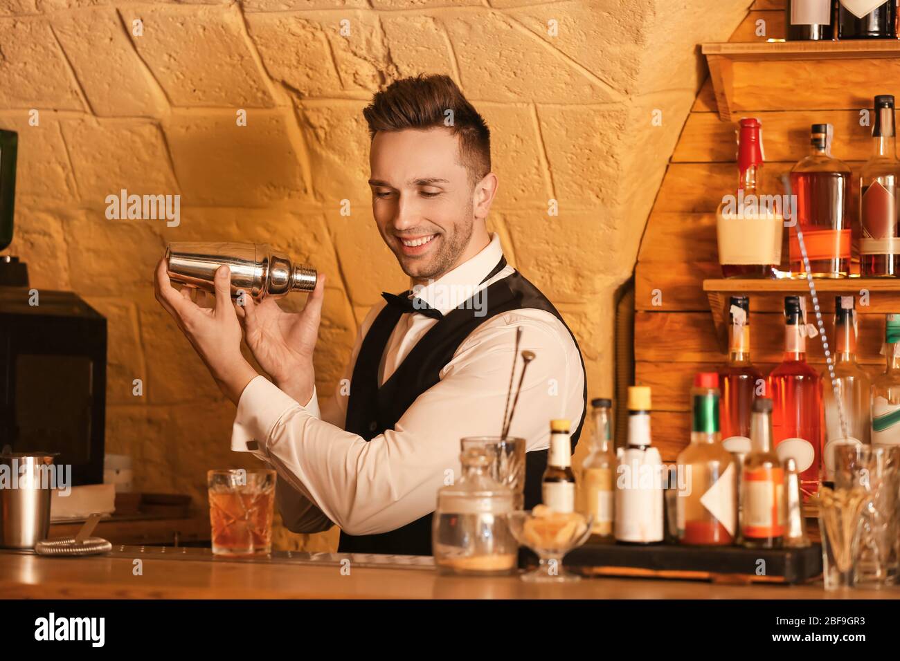 Male bartender making cocktail in pub Stock Photo - Alamy