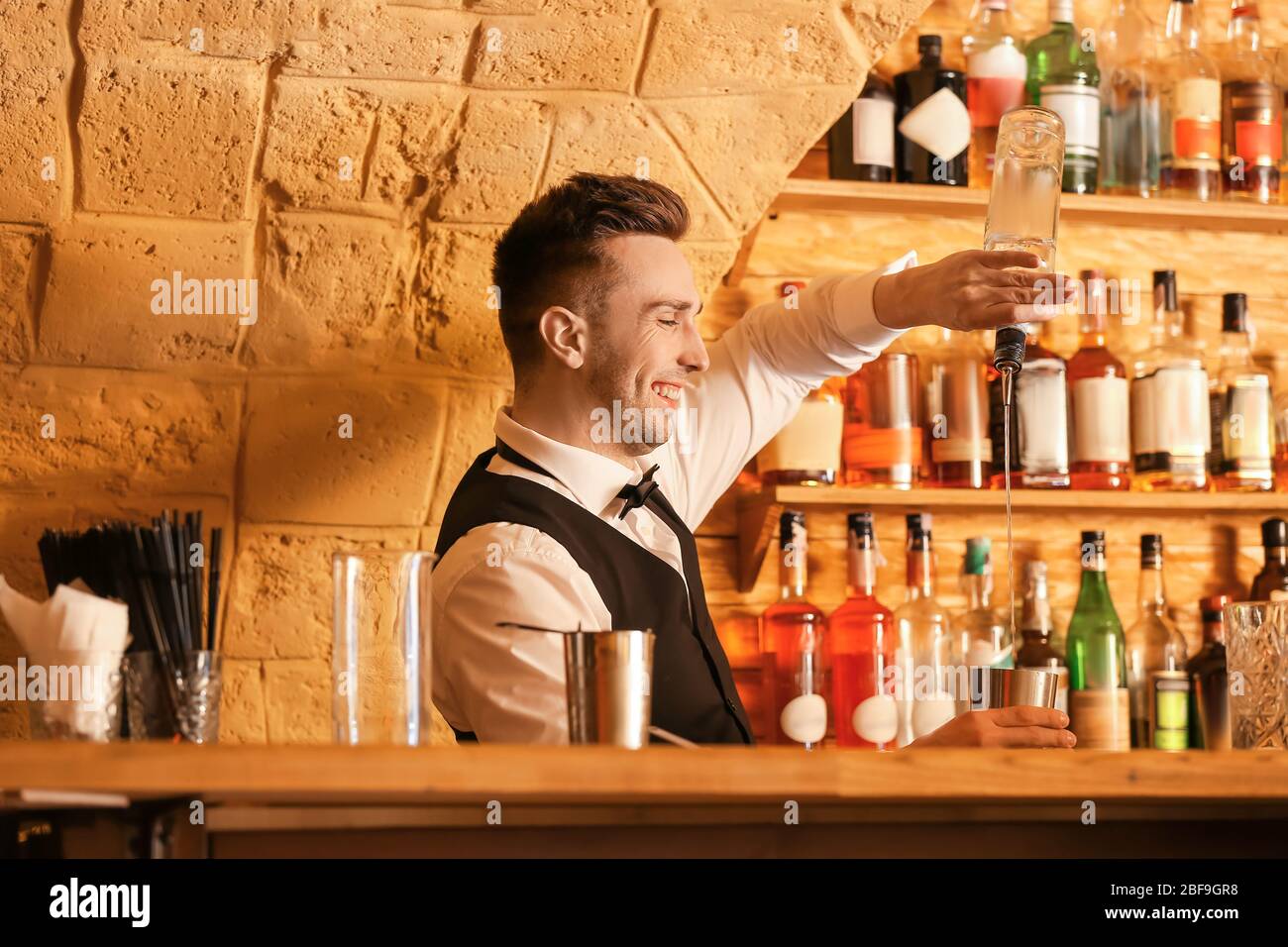 Male bartender making cocktail in pub Stock Photo - Alamy