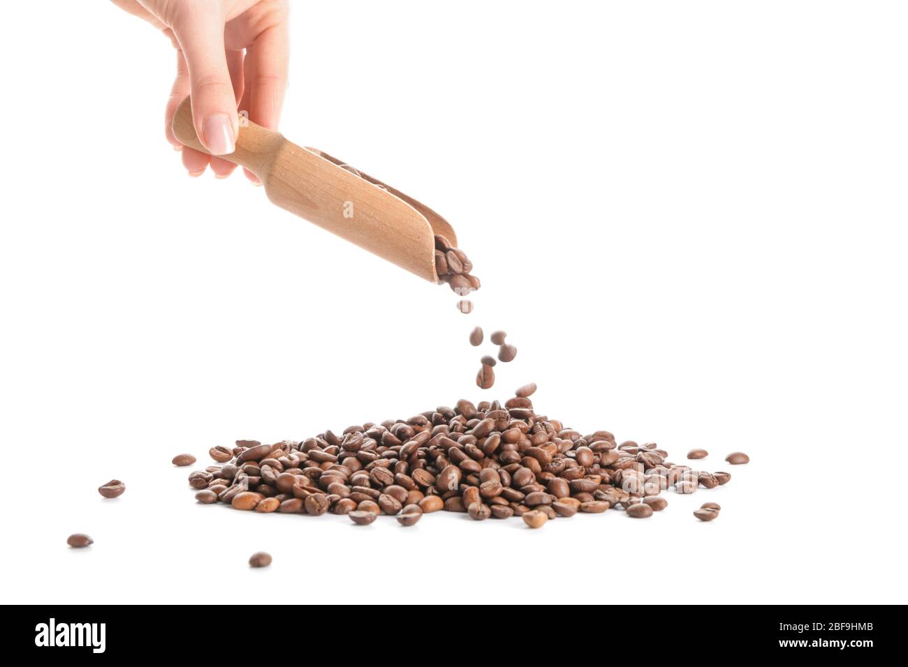 Woman pouring coffee beans on white background Stock Photo - Alamy