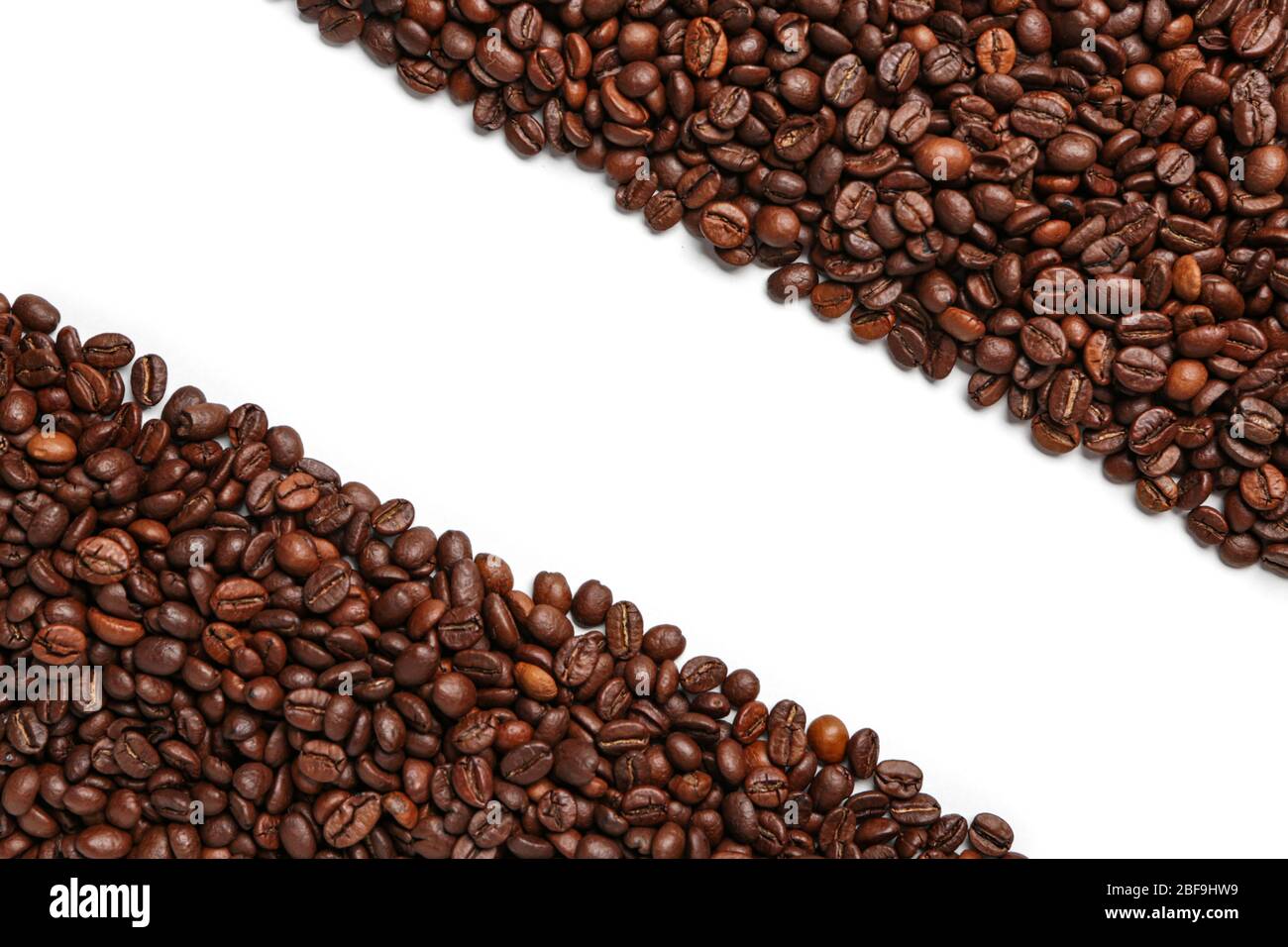 Many coffee beans on white background Stock Photo - Alamy