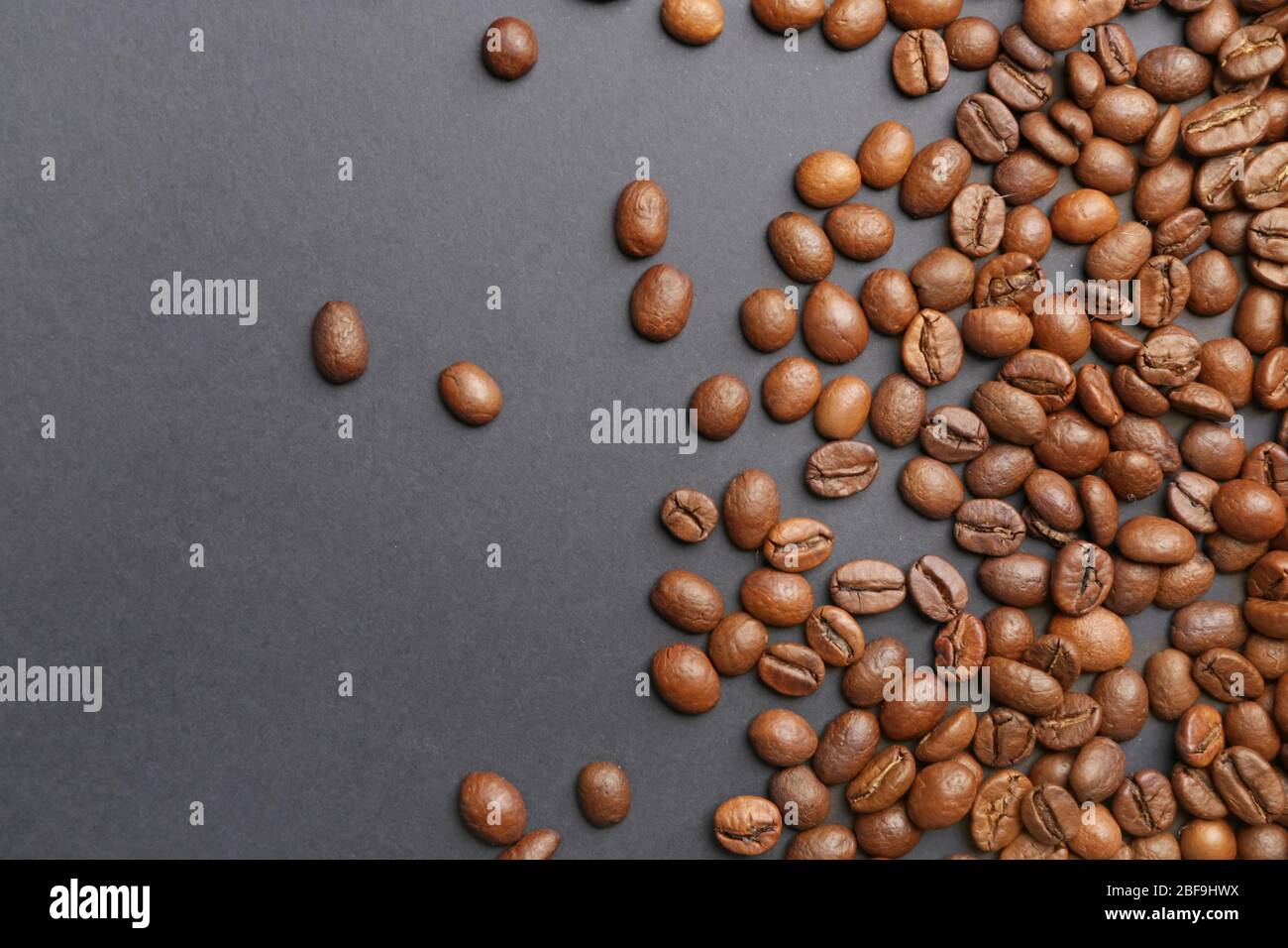 Many coffee beans on dark background Stock Photo - Alamy