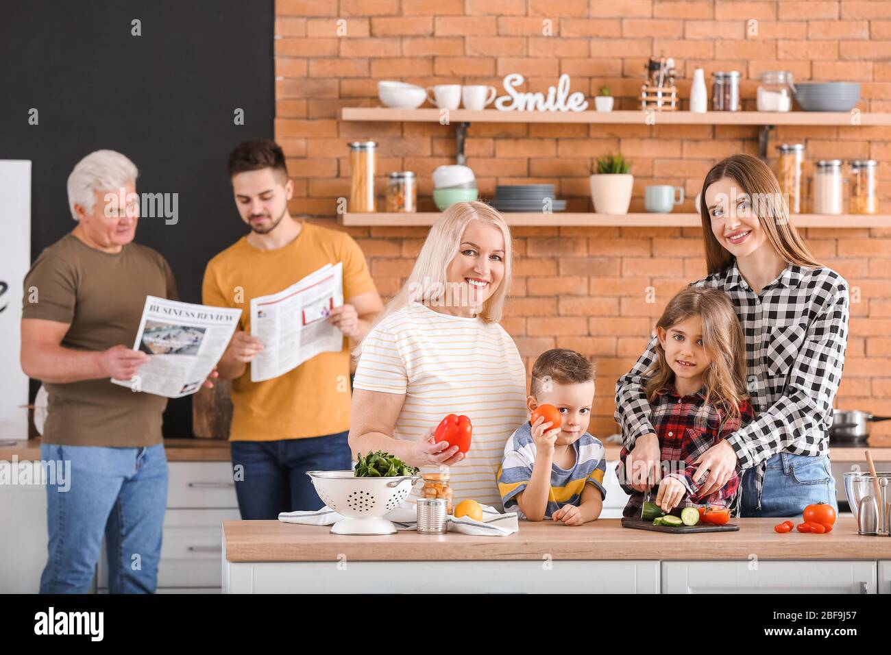 Big family cooking together in kitchen Stock Photo - Alamy