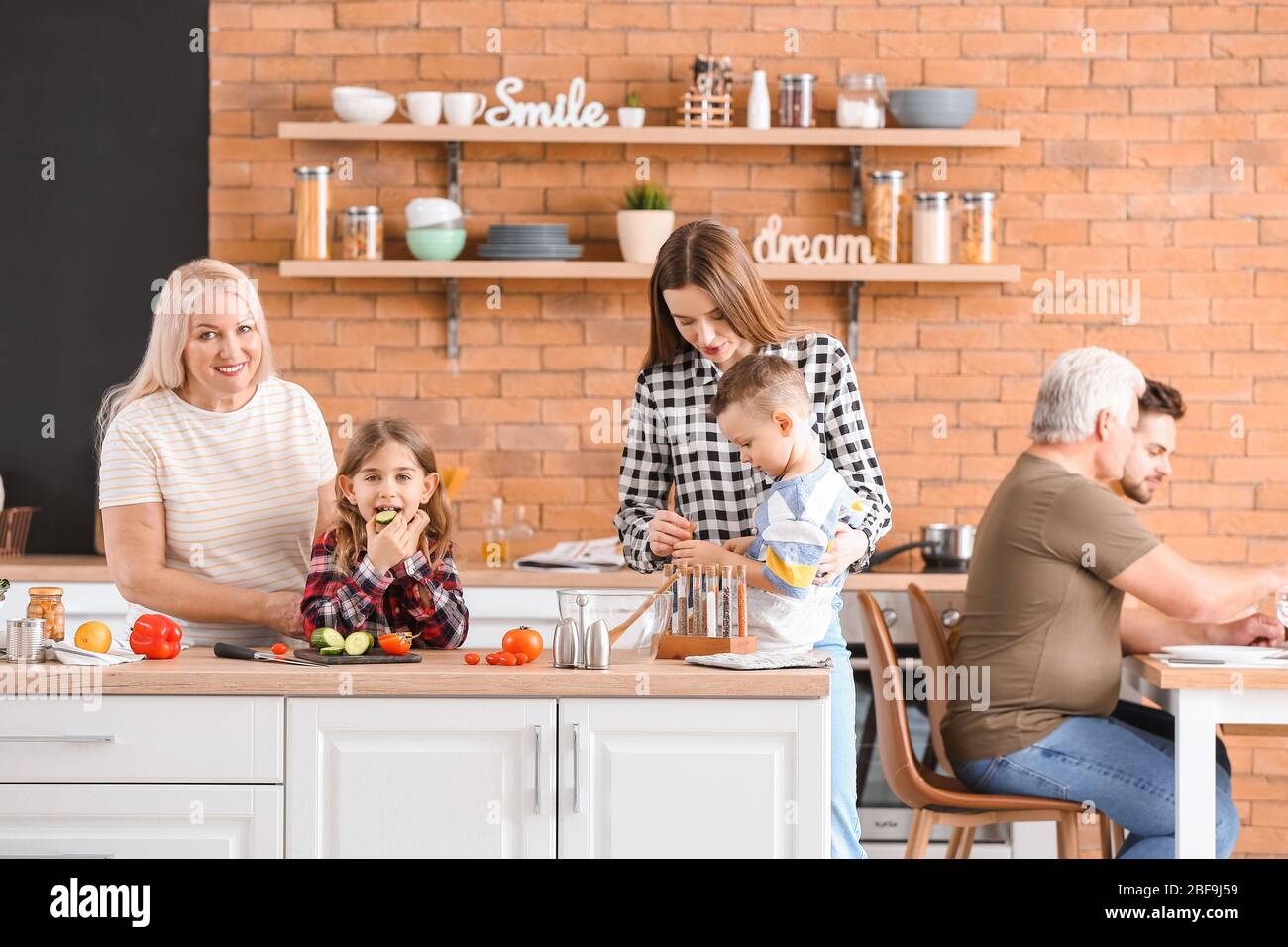 Big family cooking together in kitchen Stock Photo - Alamy